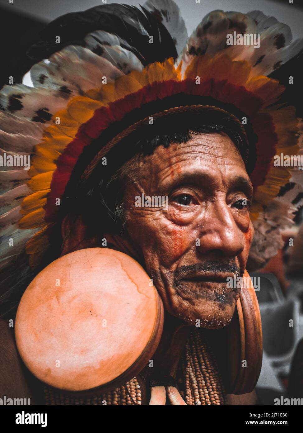 Cacique of indigenous tribe in Brazil wearing a headdress feather cocar ...