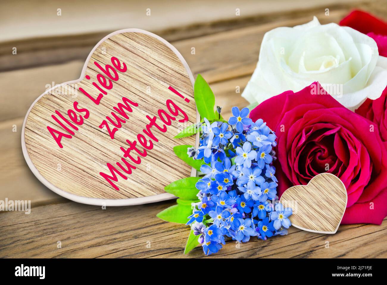 German Happy Mother's Day and Love with flowers and wooden heart Stock ...