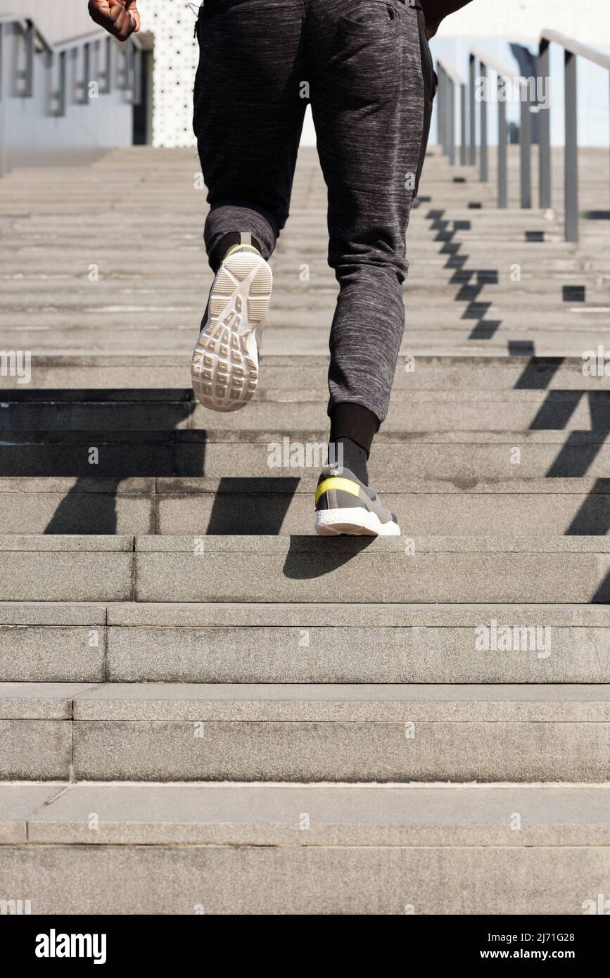 Effective step running workout. Rear view of legs of unrecognizable ...