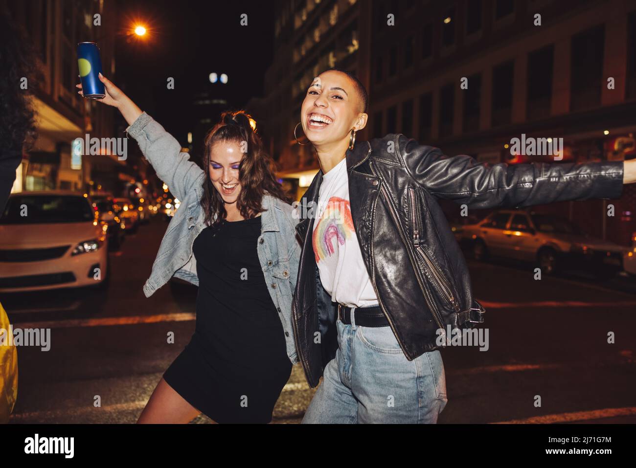 Celebrating with dance. Two happy female friends dancing cheerfully ...
