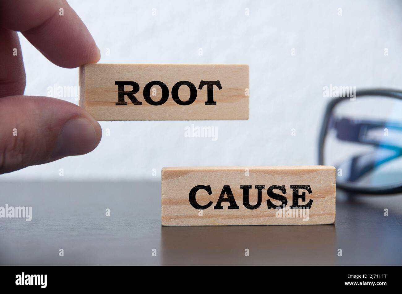 Hand holding wooden block with text - Root cause analysis. Problem ...