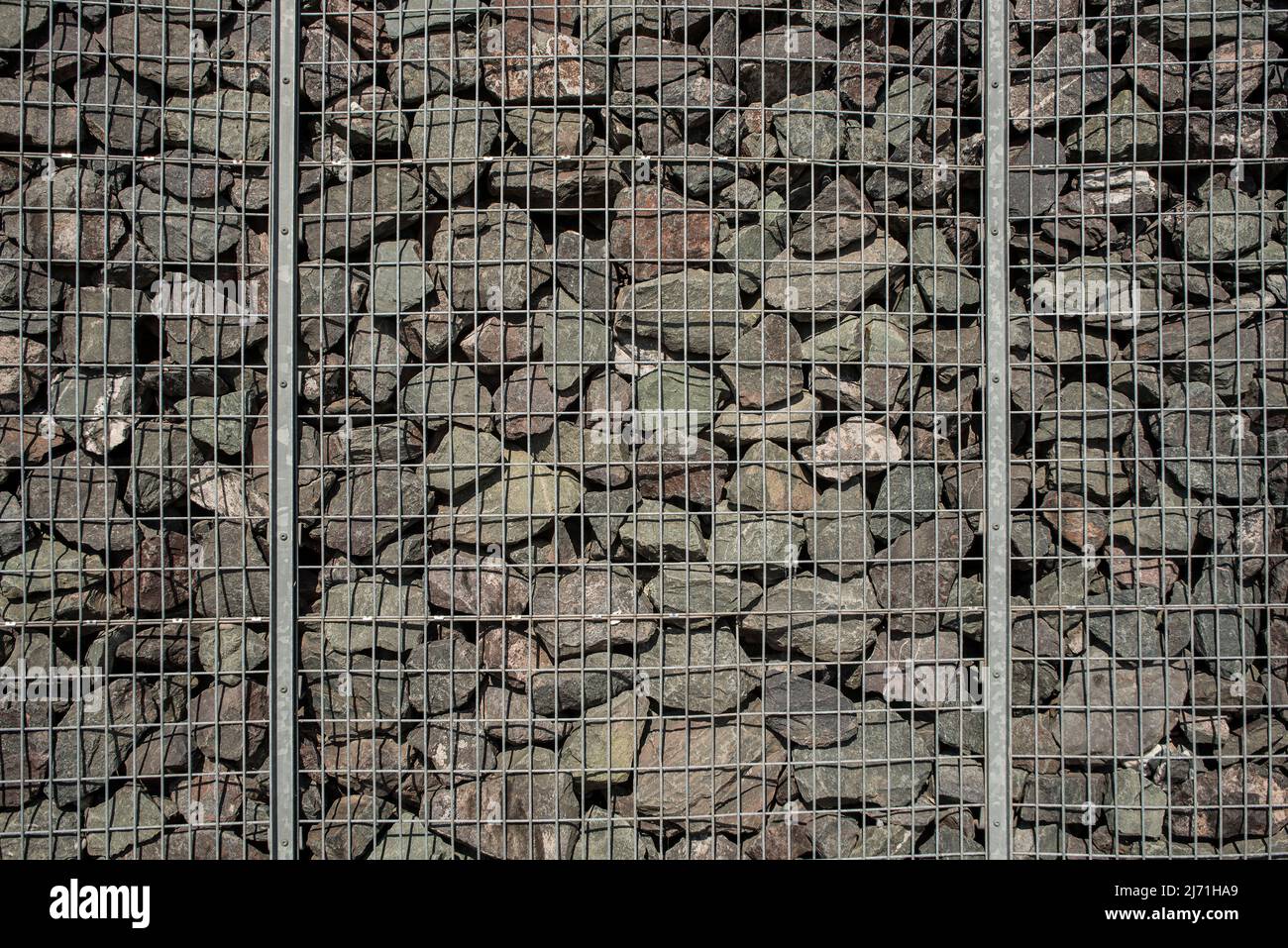 Close up of a gabion, rocks packed into a wire mesh form typically to ...