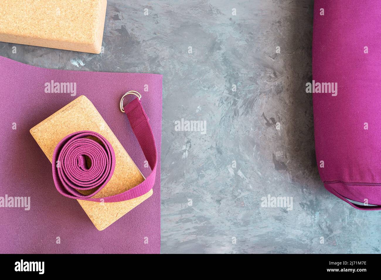 Open yoga mat, cork block, yoga belt and bolster. Essentials yoga props ...