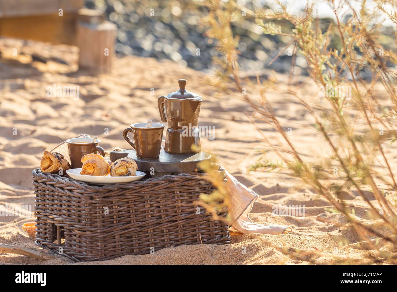 Breakfast on the beach for two. Coffee maker with cups and French ...