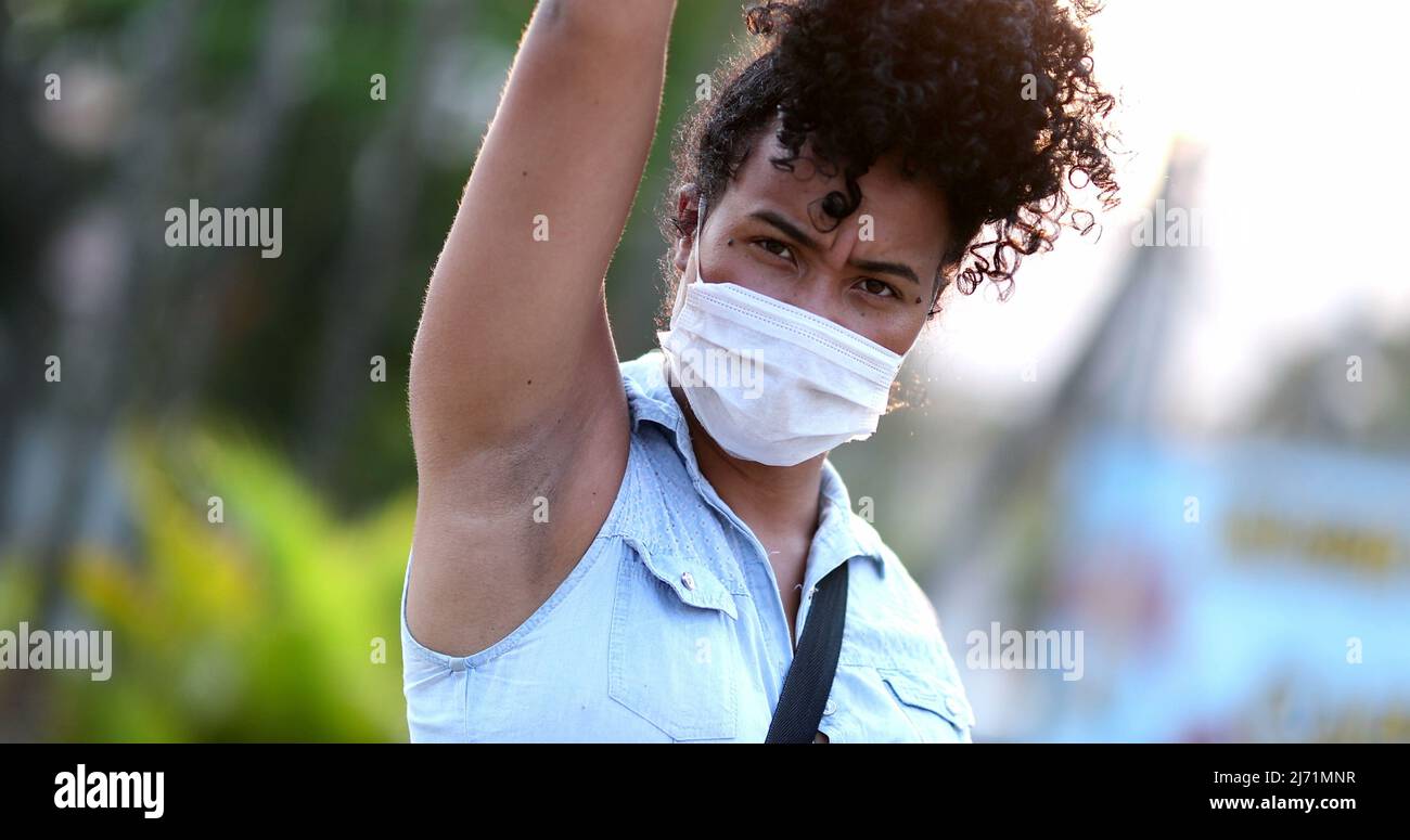 African American woman raises fist in air in political movement, black ...