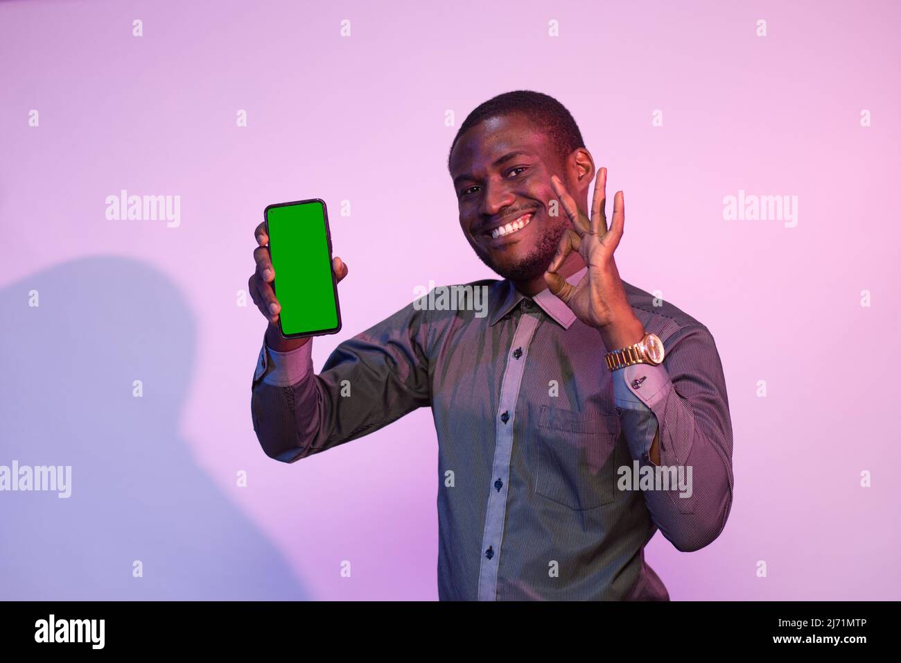 excited african man showing his phone screen Stock Photo - Alamy
