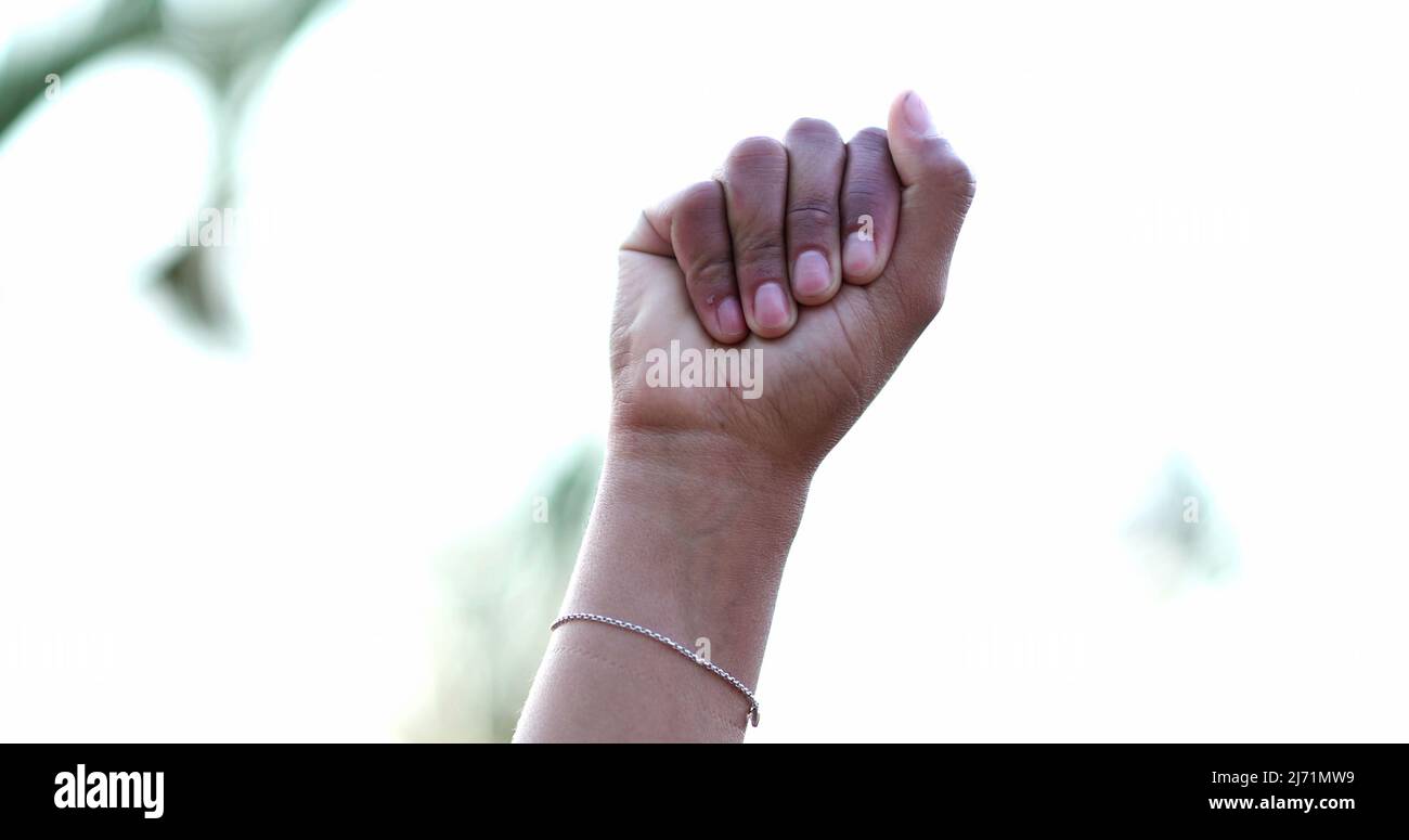 Black woman activist raising fist in air in political movement Stock ...