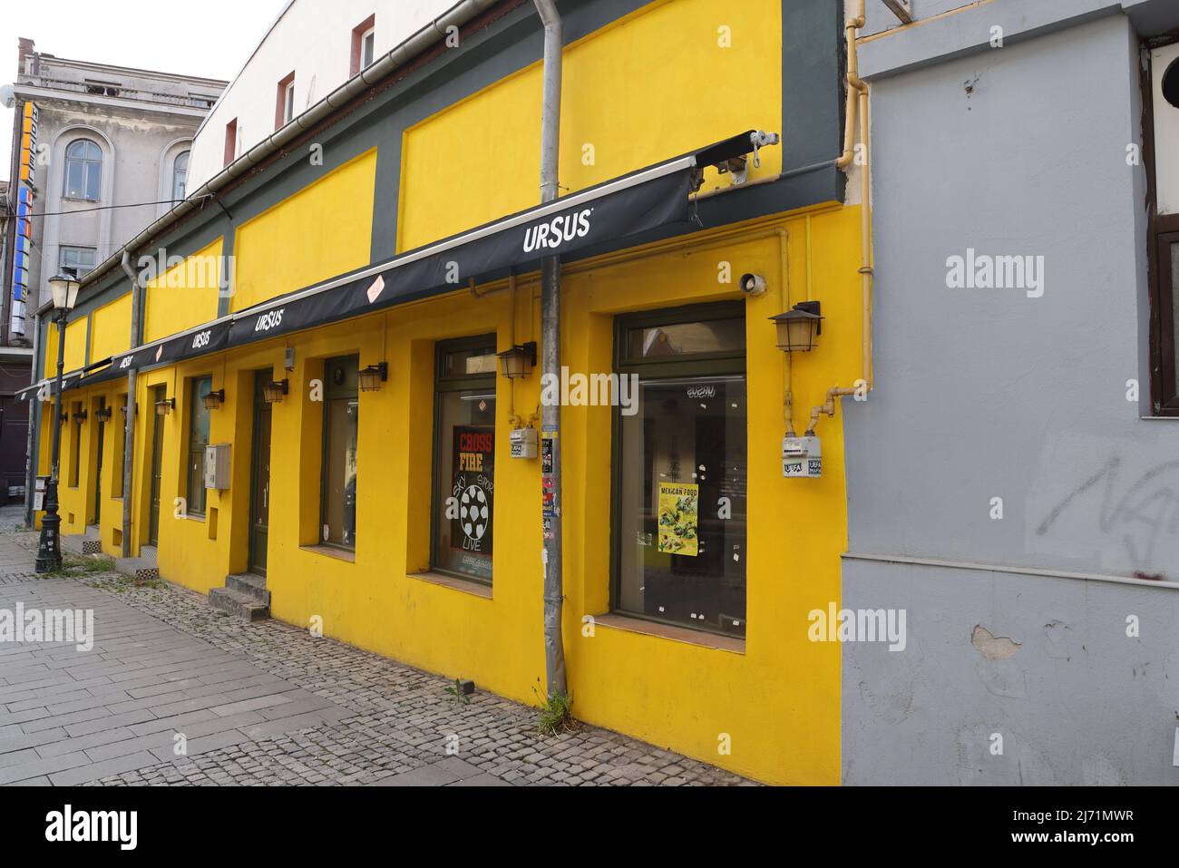 Bright yellow wall of building in Bucharest, Romania Stock Photo - Alamy