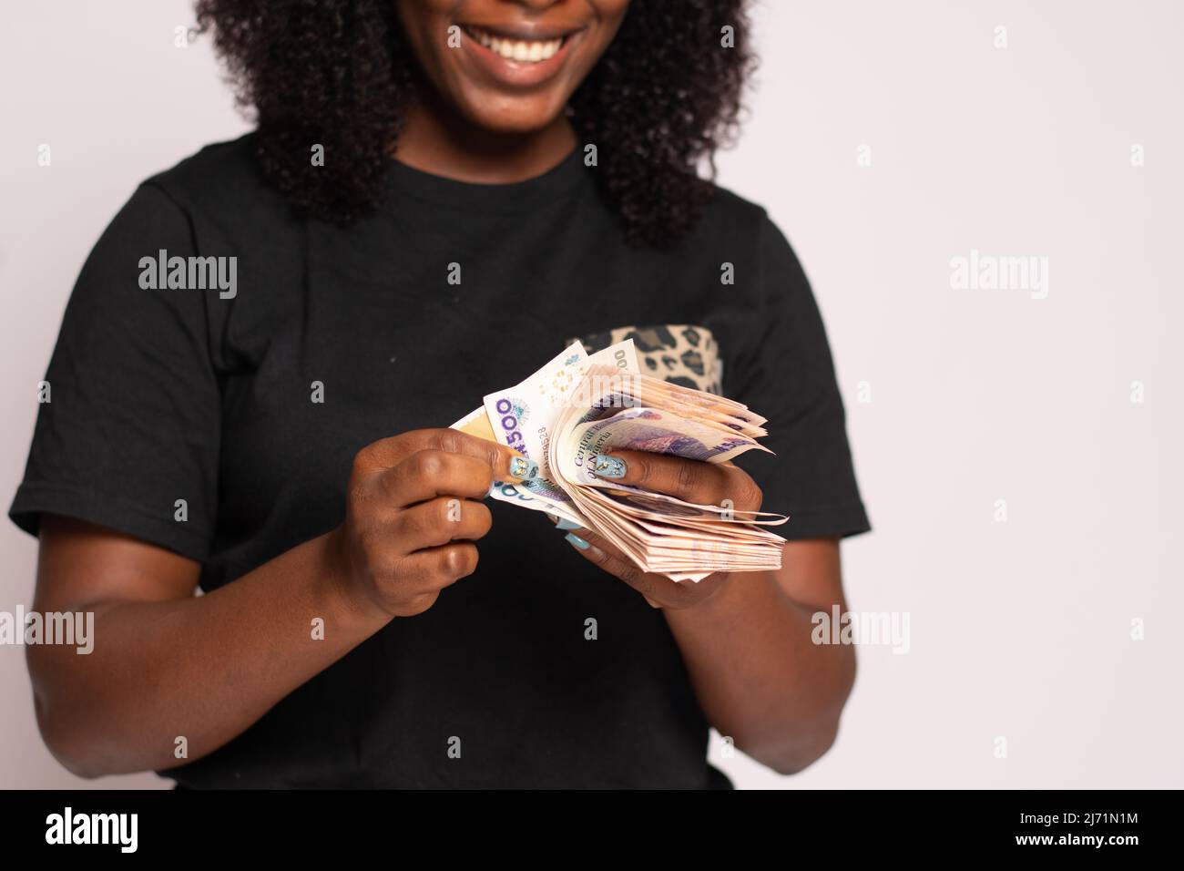 nigerian lady counting some money Stock Photo - Alamy