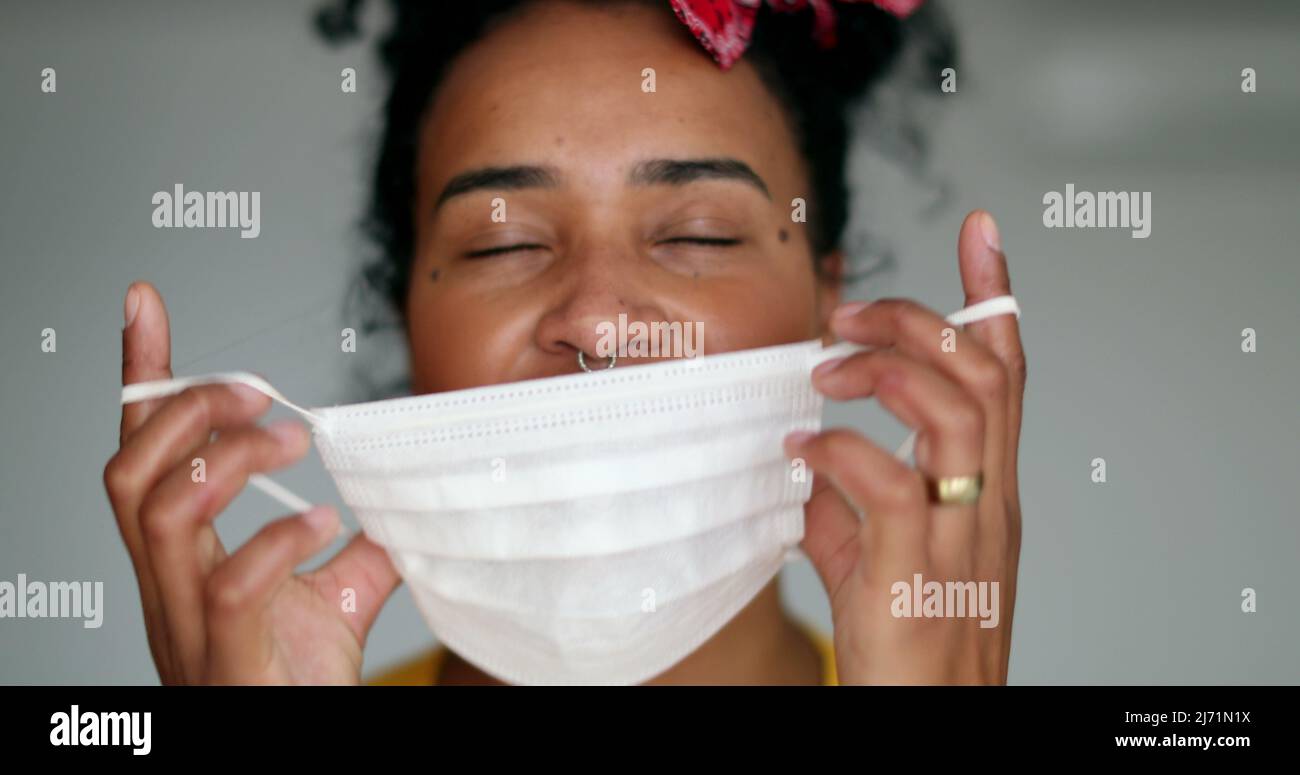 Happy young black woman taking off pandemic mask feeling relief Stock ...