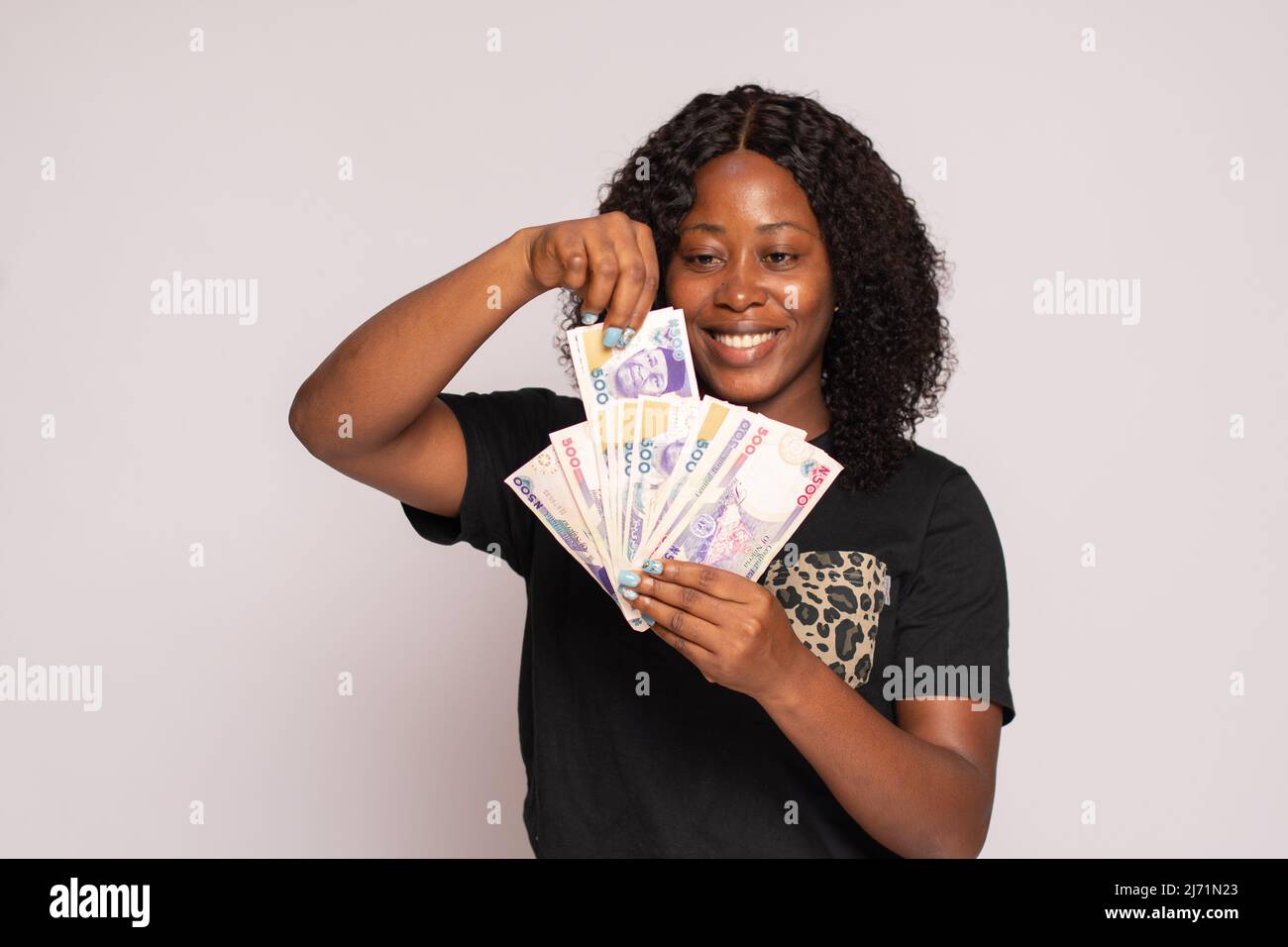young african lady showing of some money Stock Photo - Alamy