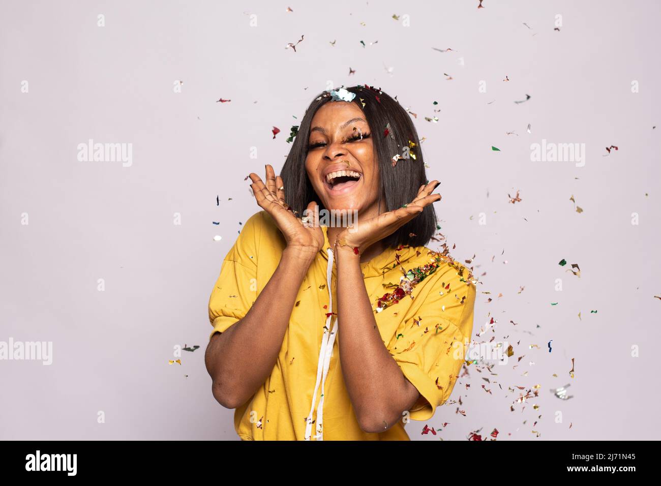 pretty african lady feeling excited and happy, with confetti Stock ...