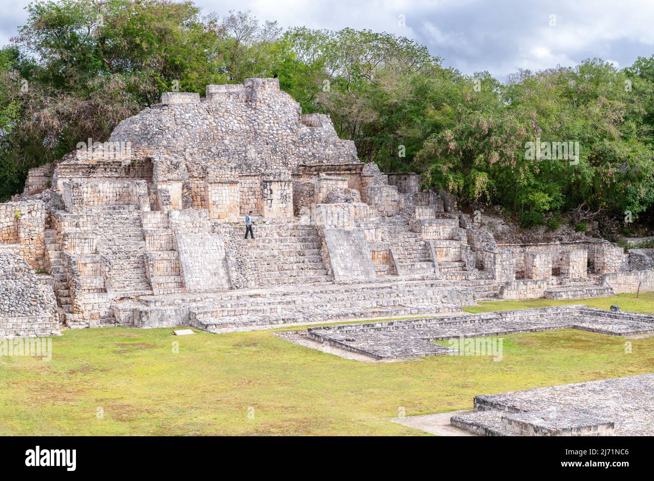 Tourist man posing in front of the ruins of north temple of ancient ...