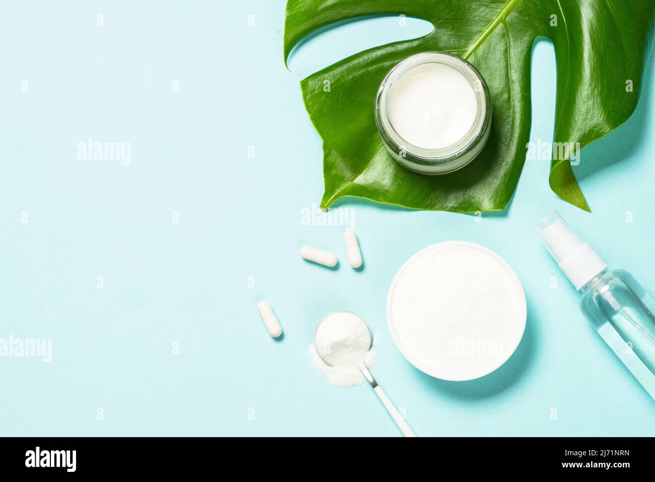 Collagen products and cosmetic at blue top view Stock Photo - Alamy