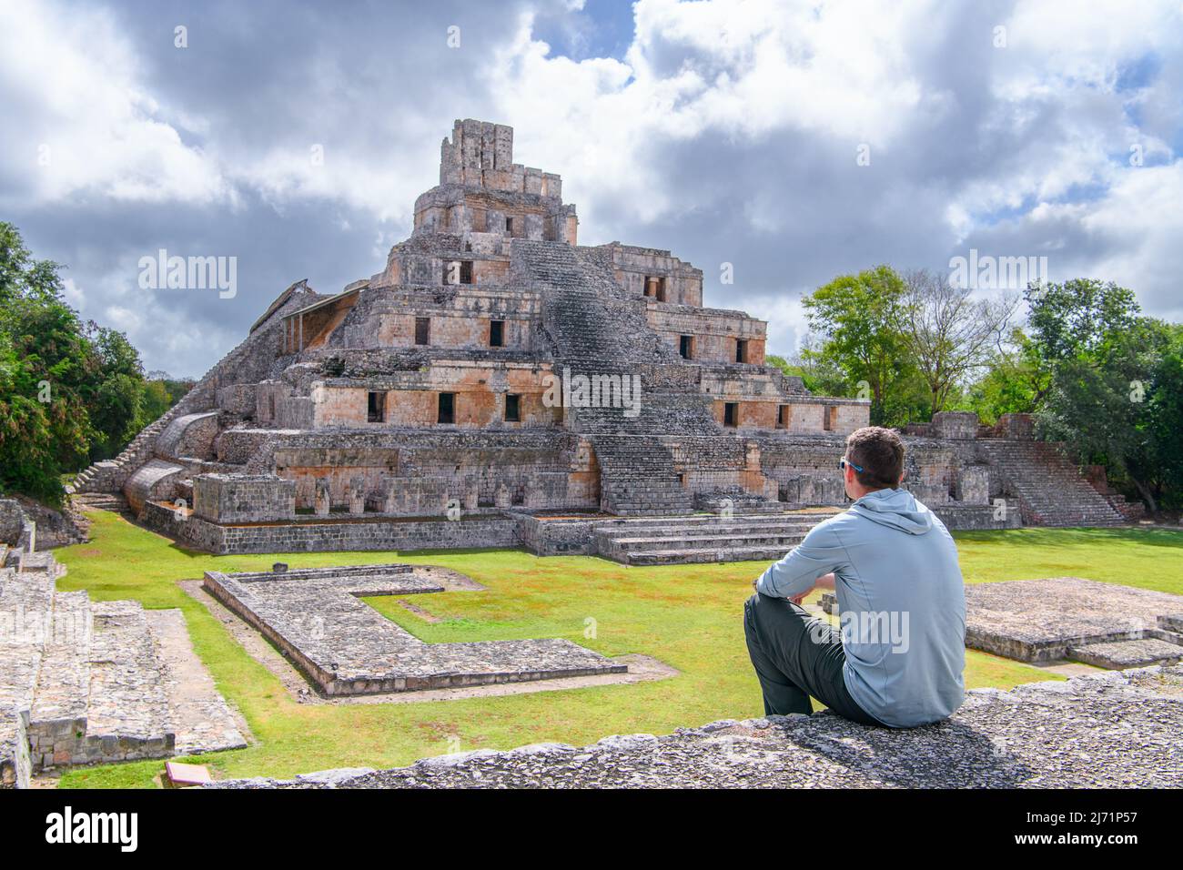 Tourist man visiting mayan ruins of Temple of the Five Storeys, Edzna ...