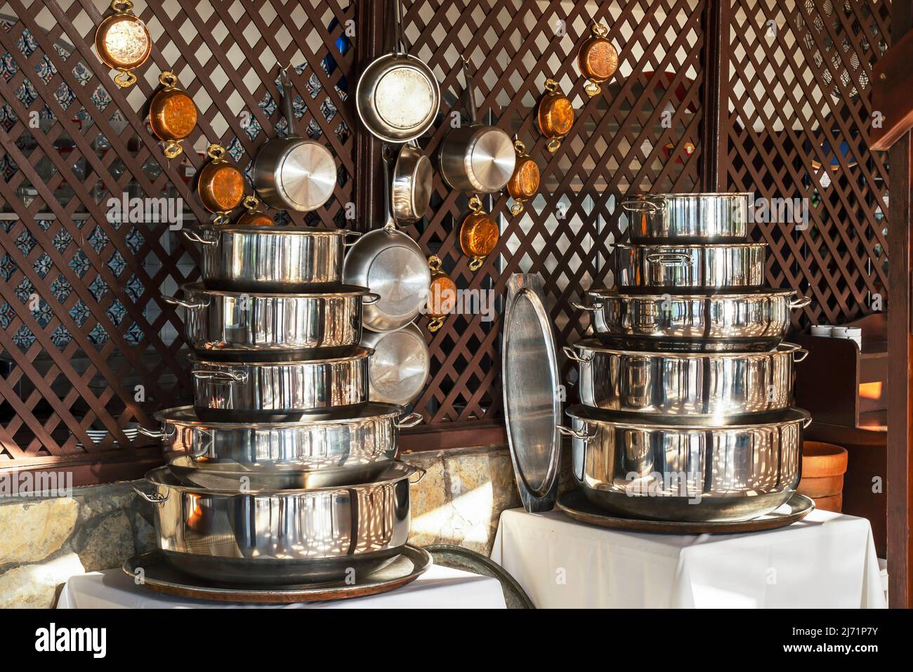 kitchen pans stand in a stack outside in the shade, a set of kitchen ...