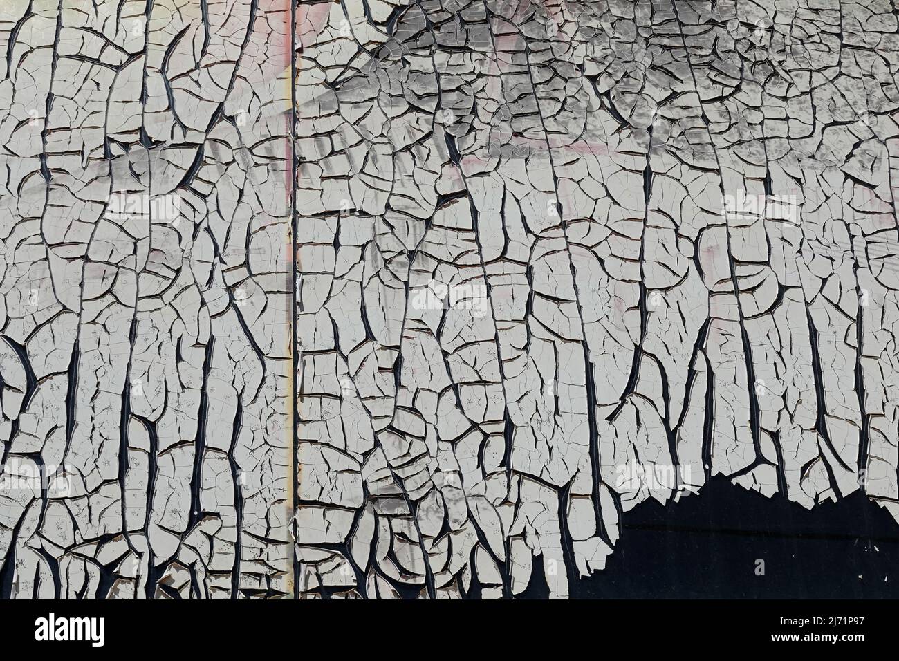 Cracked adhesive plastic film layer on glass surface. Grungy background ...