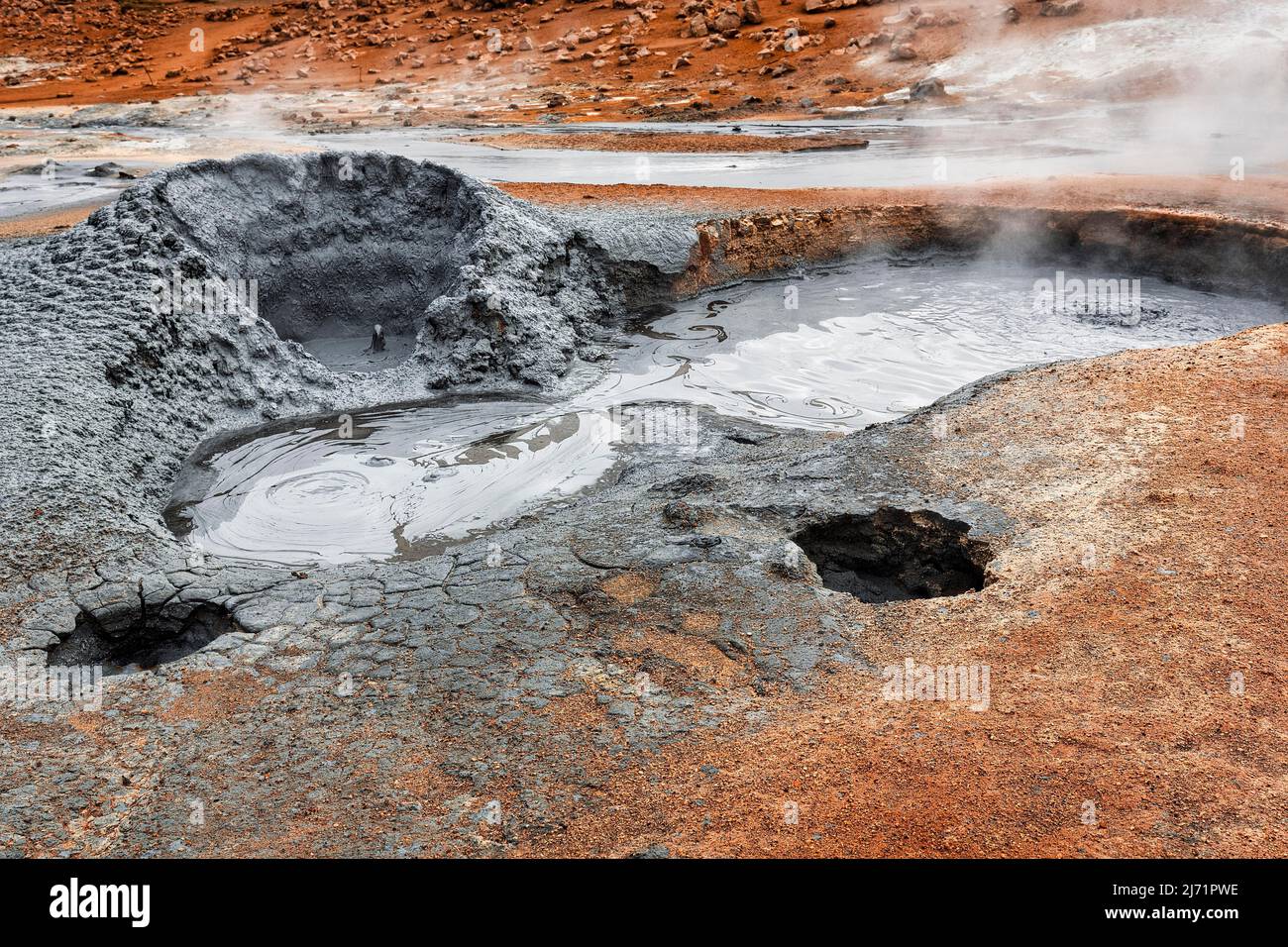 Bubbling mud pot, steaming fumaroles, Hveraroend geothermal area, also ...