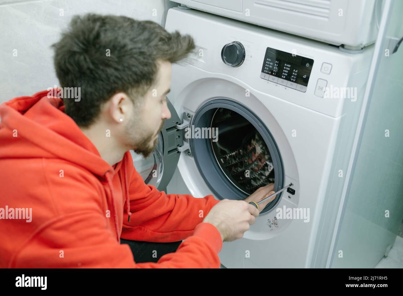 Man fixing washing machine hi-res stock photography and images - Alamy