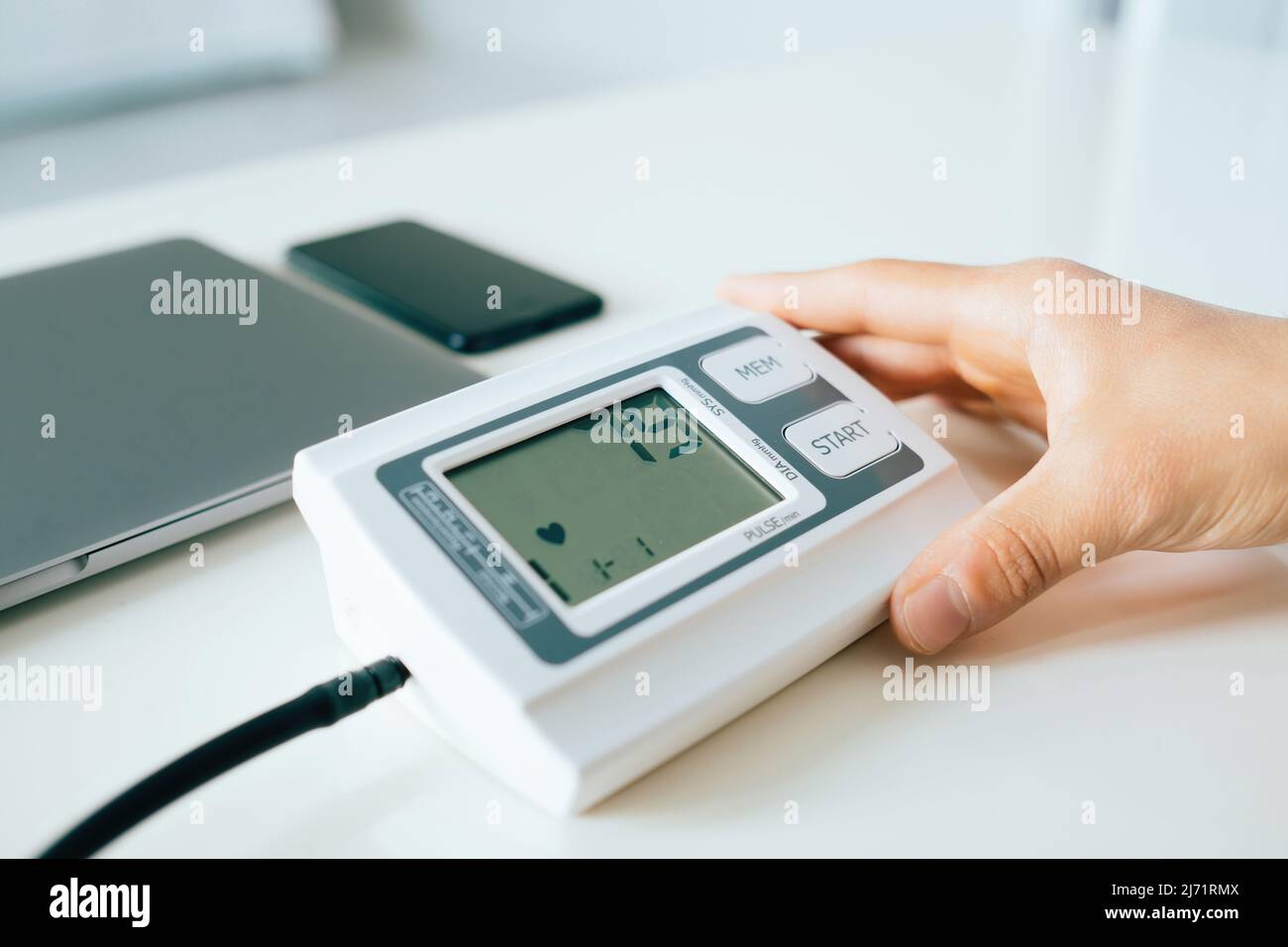 Young man checking, measuring blood pressure with digital tonometer at ...
