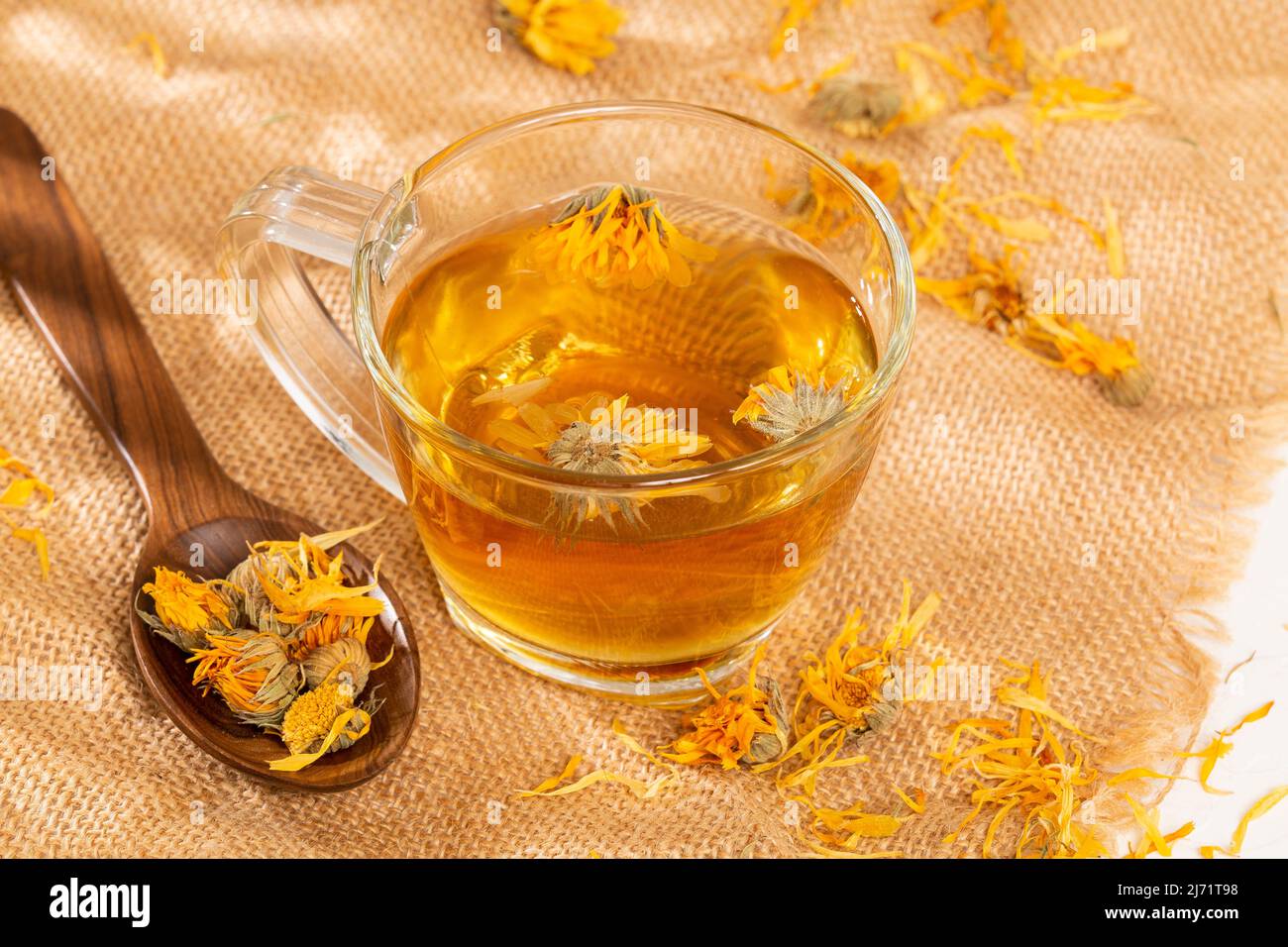 A cup of herbal medicinal tea dried calendula and marigold flowers ...