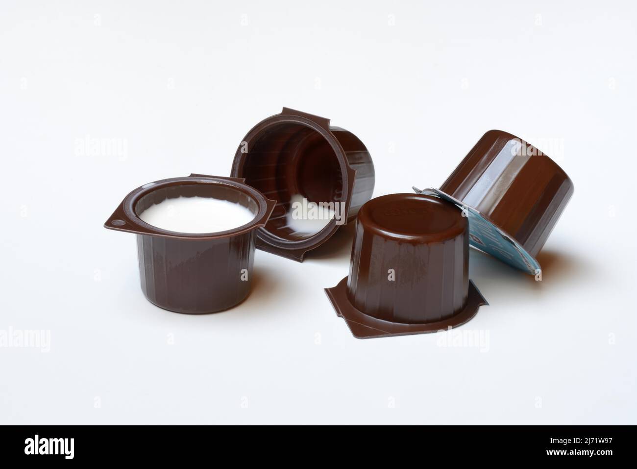 Milk in portion pack, plastic packaging, white background Stock Photo ...