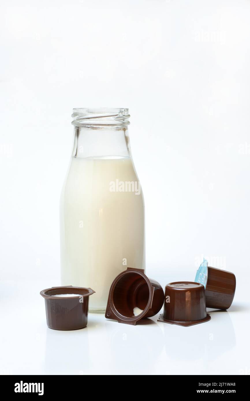 A bottle of milk and milk in portion pack, white background Stock Photo ...