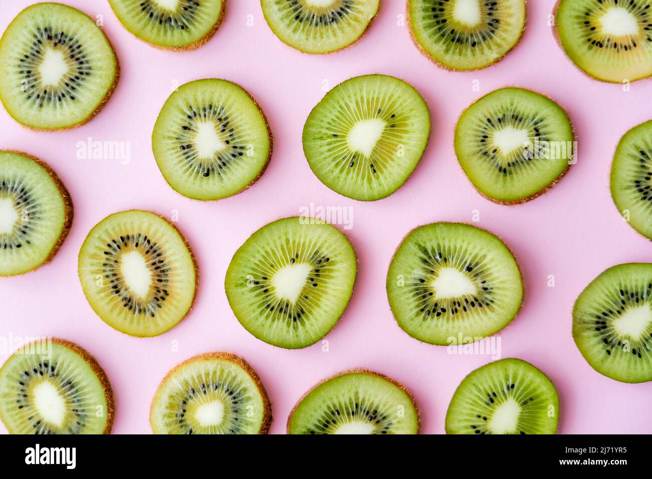 top view of sliced fresh kiwi on pink Stock Photo - Alamy