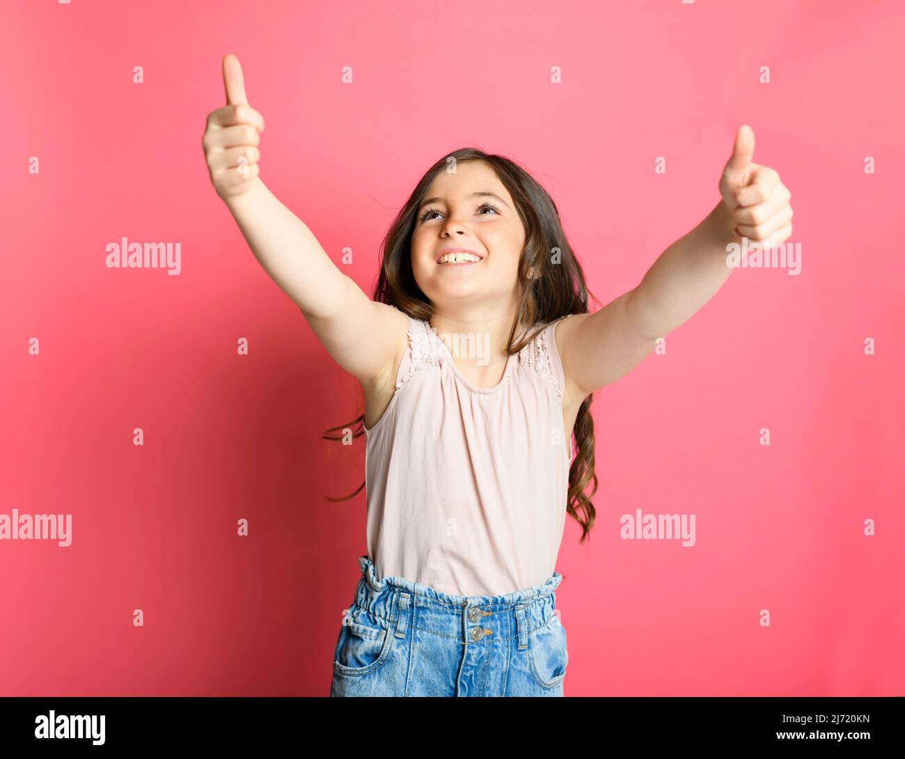 cute positive thumb up child over pink backgroud on studio Stock Photo ...