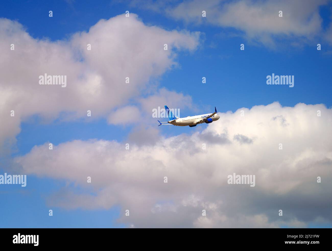 MIAMI, FL -13 MAR 2022- View of an airplane in flight from United ...