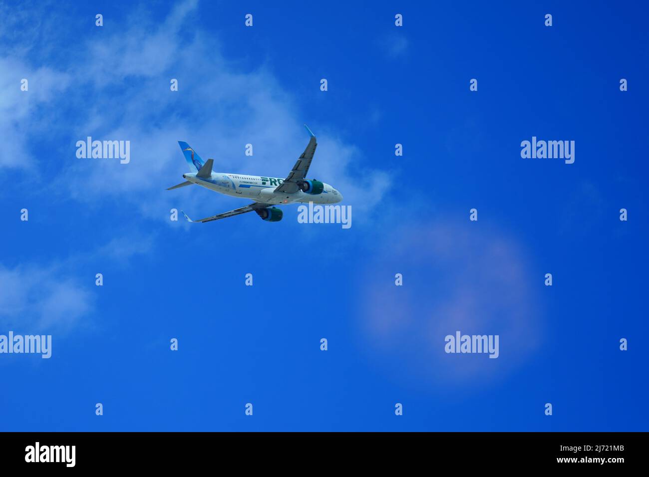 MIAMI, FL -13 MAR 2022- View of an airplane in flight from lowcost ...