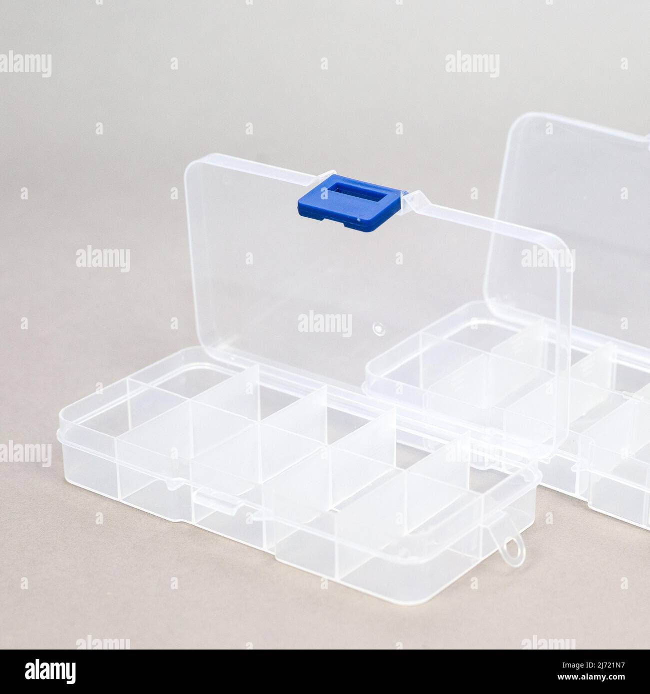 Plastic transparent boxes with individual cells with a blue lid white ...