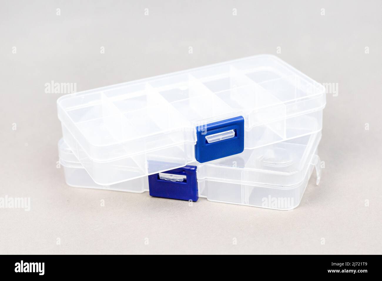 Plastic transparent boxes with individual cells with a blue lid on a ...
