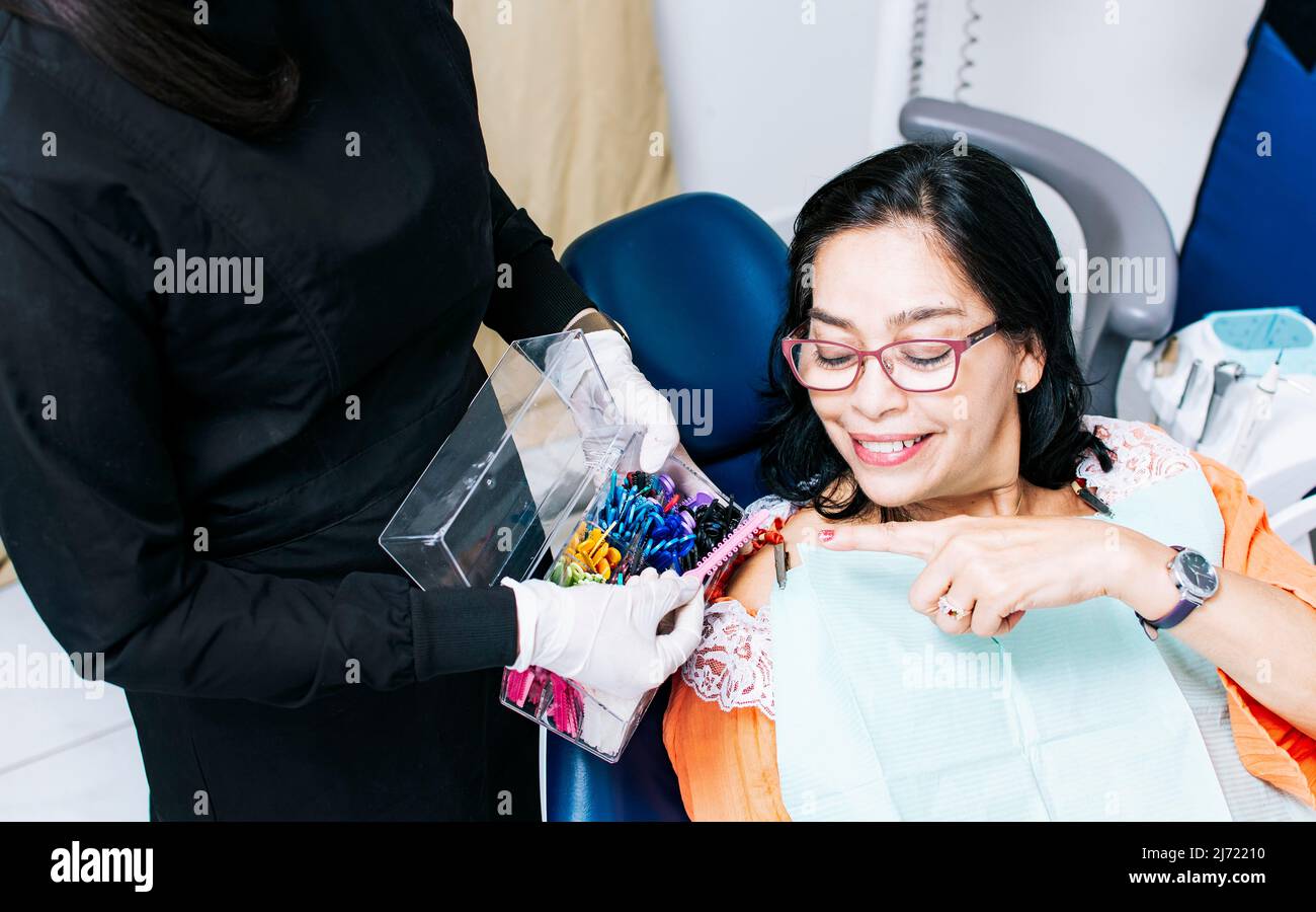 Patient with dentist choosing dental braces, Dentist with patient ...
