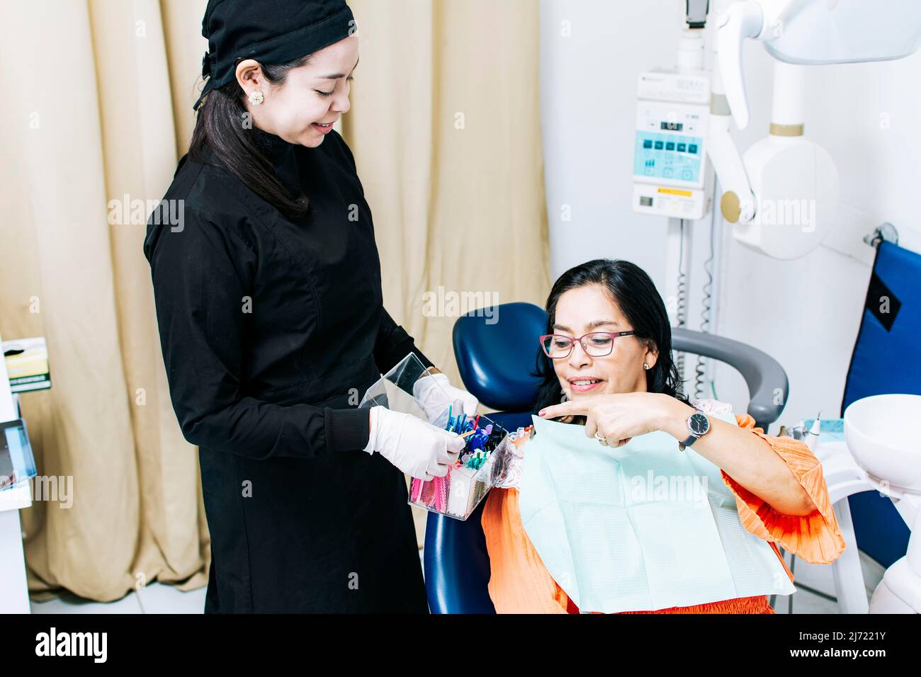 Patient with dentist choosing dental braces, Dentist with patient ...