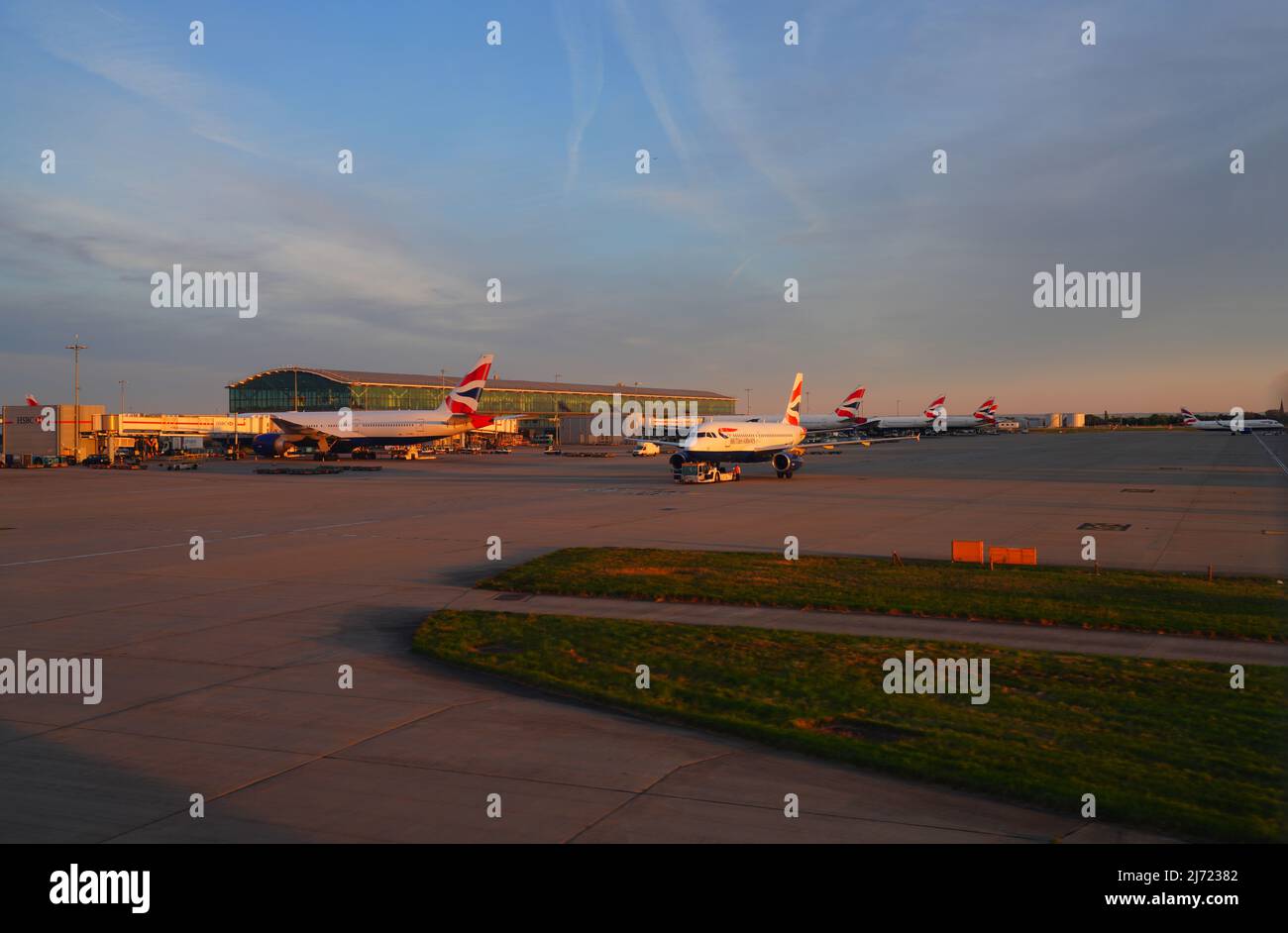 HEATHROW, ENGLAND -17 APR 2022- Sunset view of airplanes from British ...