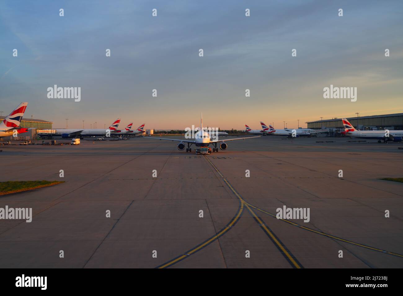 HEATHROW, ENGLAND -17 APR 2022- Sunset view of airplanes from British ...