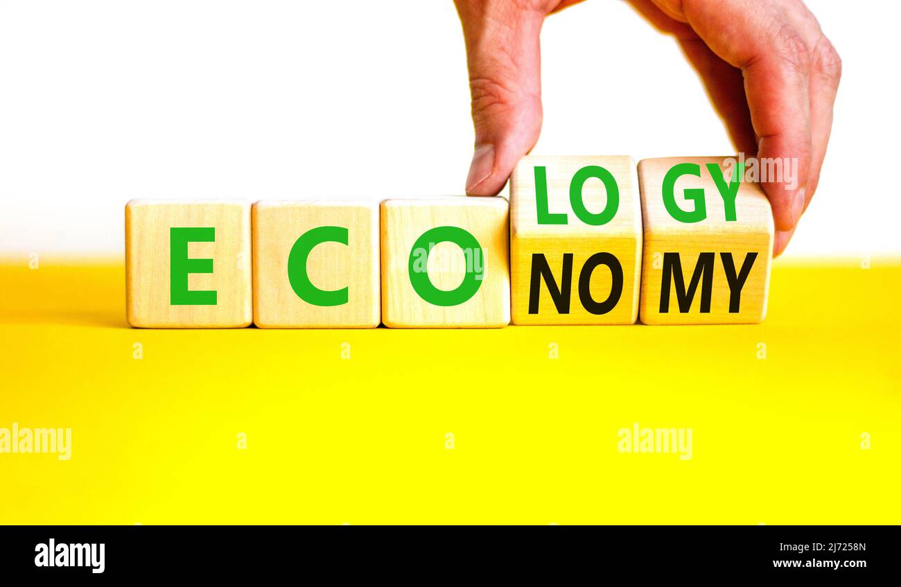 Ecology or economy symbol. Businessman turns wooden cubes and changes ...