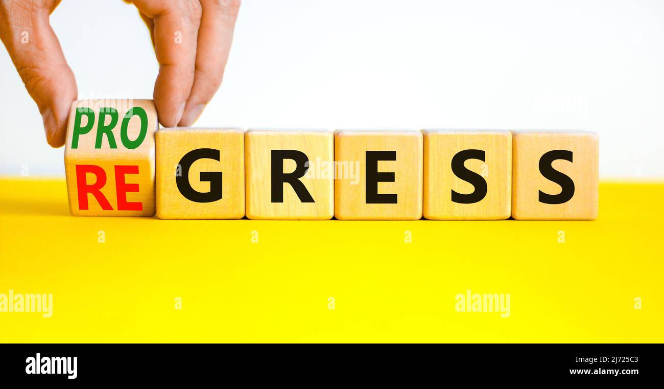Regress or progress symbol. Businessman turns wooden cubes and changes ...