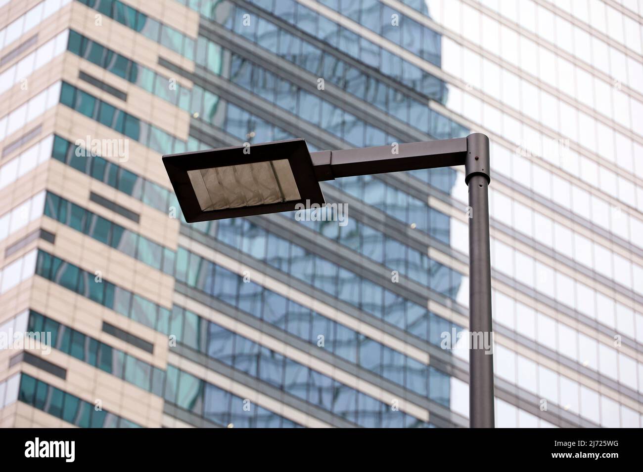 LED street lamp post on skyscraper background. Modern led lights in ...