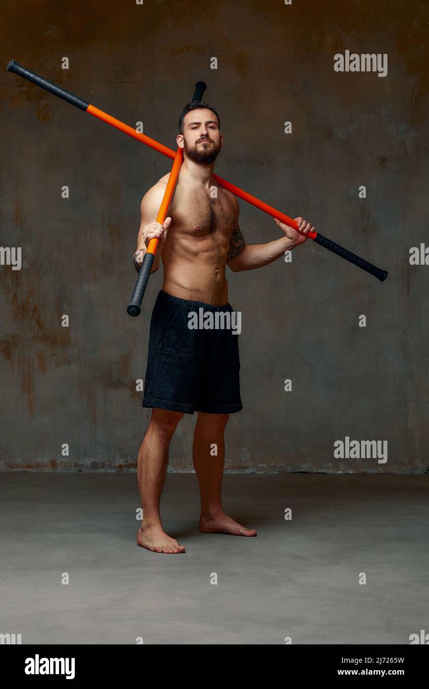 athlete men with stick training karate using sports tool in studio on ...