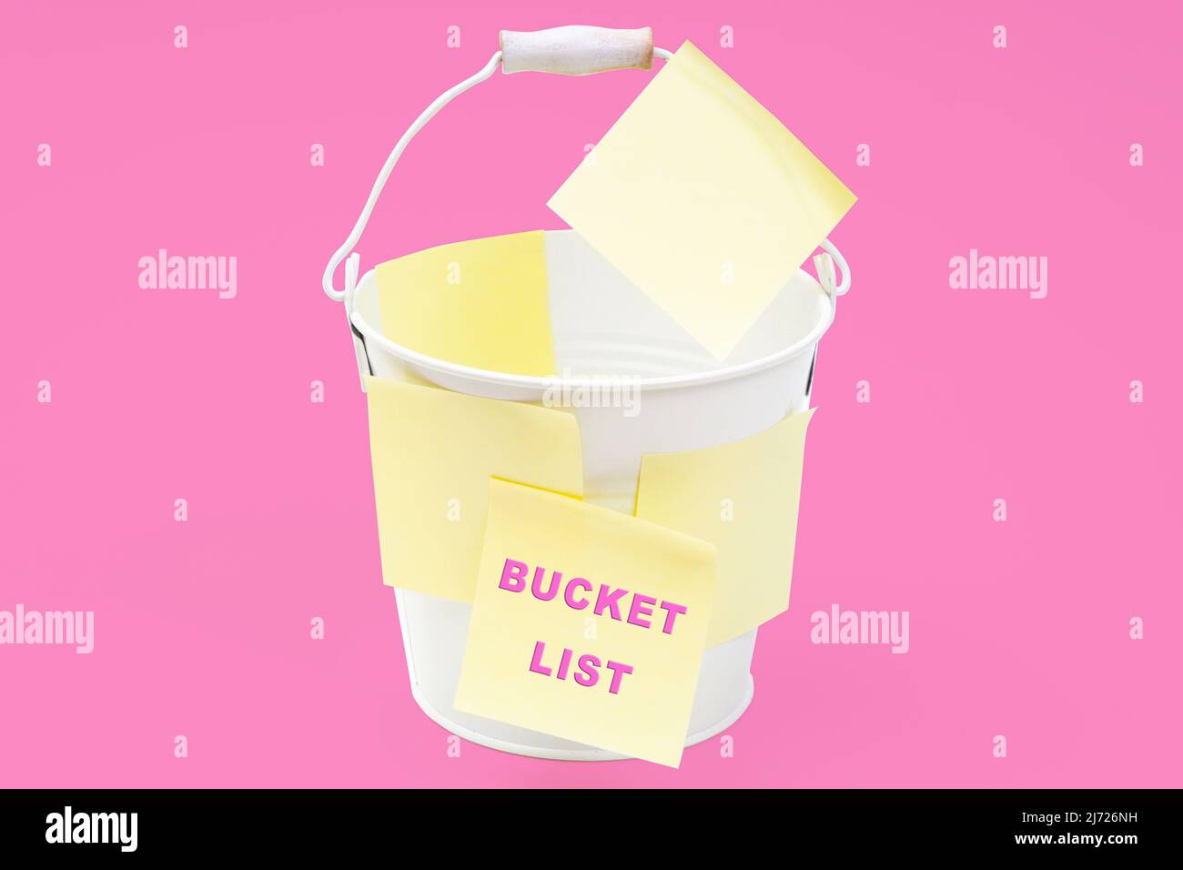 Small steel bucket covered with note stickers reading BUCKET LIST ...