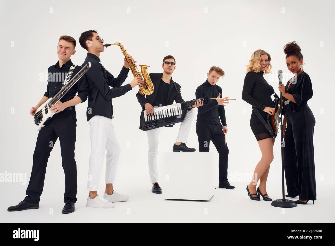 Portrait of diverse group of young people musical band playing with ...