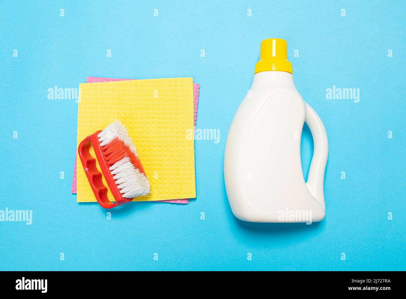 Detergent for various surfaces and a rag on a blue background ...