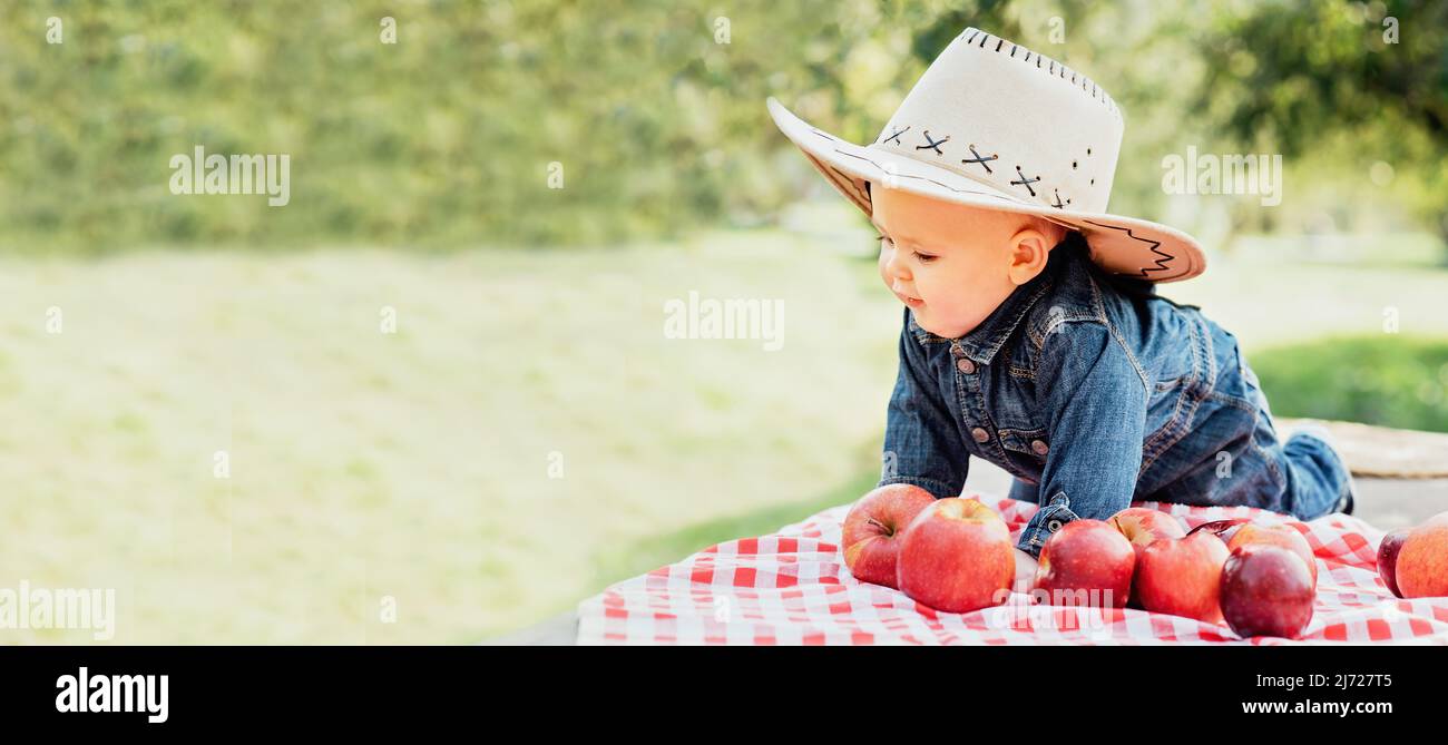 Boy with Apple in Orchard. Harvest Concept. Garden, Toddler eating fruits at fall harvest. Apple ...