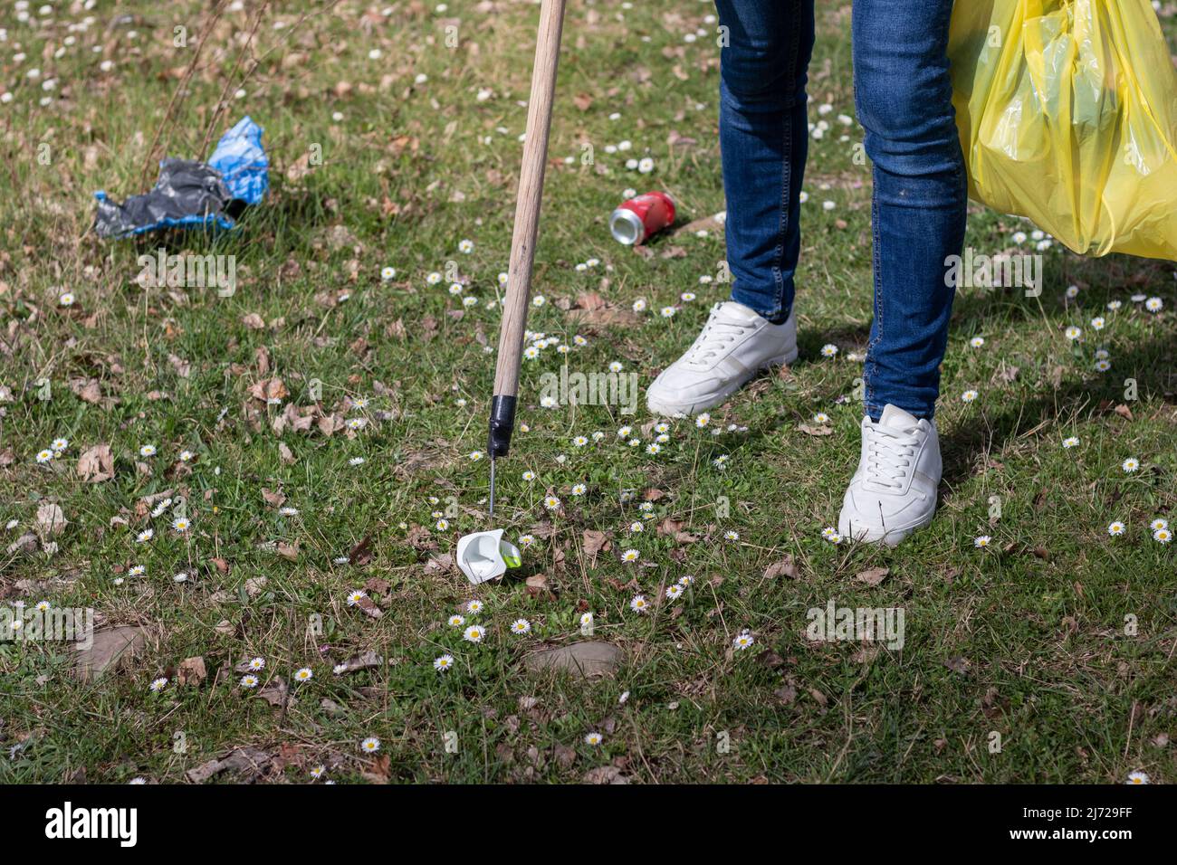 Close up of floor and legs of young man collecting plastic garbage and ...