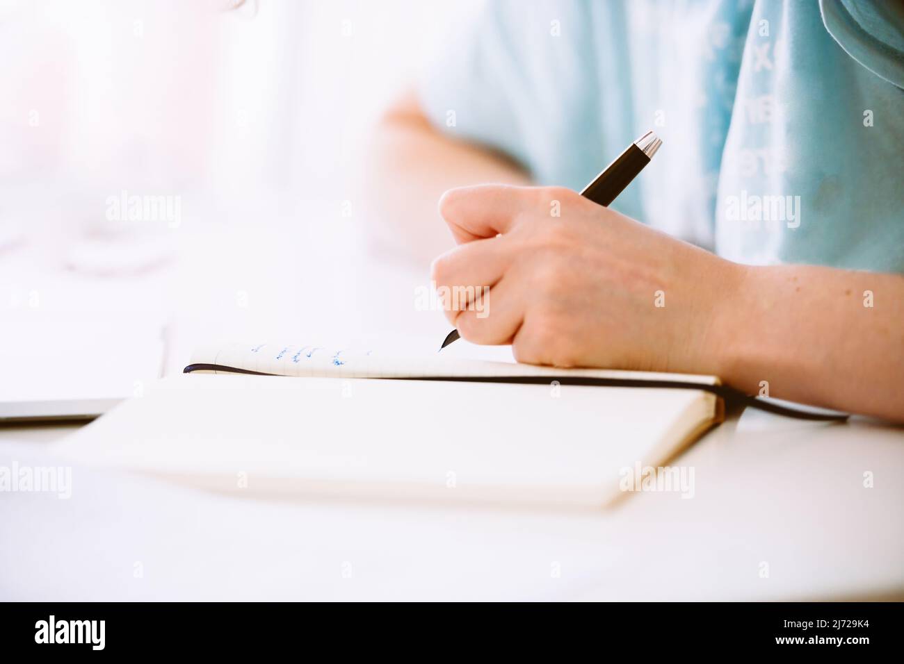 Side view of woman using fountain pen writing in her notebook Stock ...
