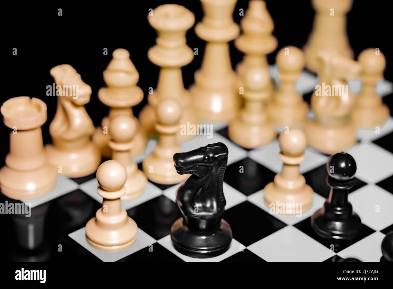 Close up of Chess pieces on a reflective mirror board surface with a ...