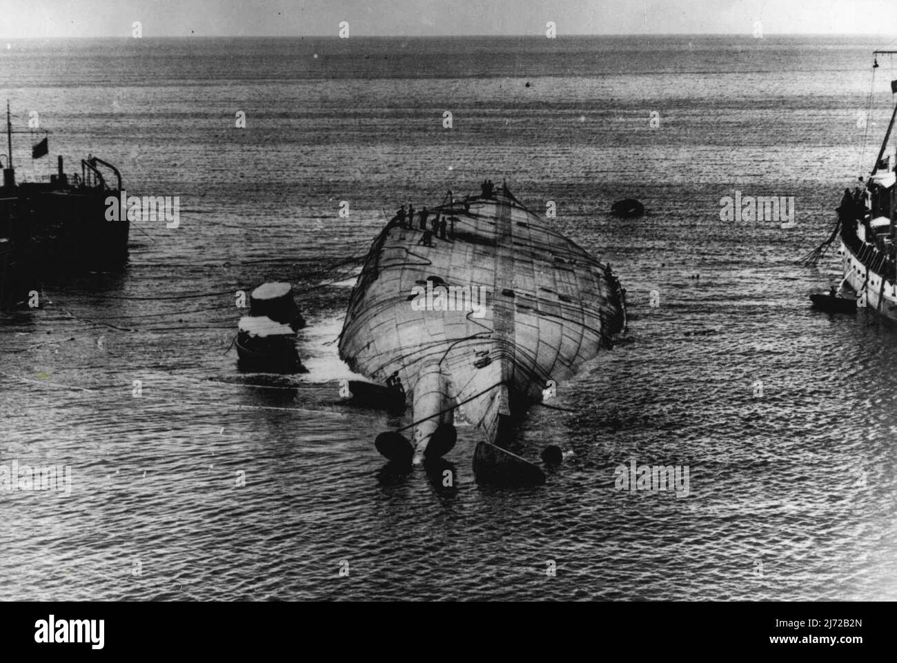 Raising H.M.S. "Breconshire" -- Salvage experts standing on the ...