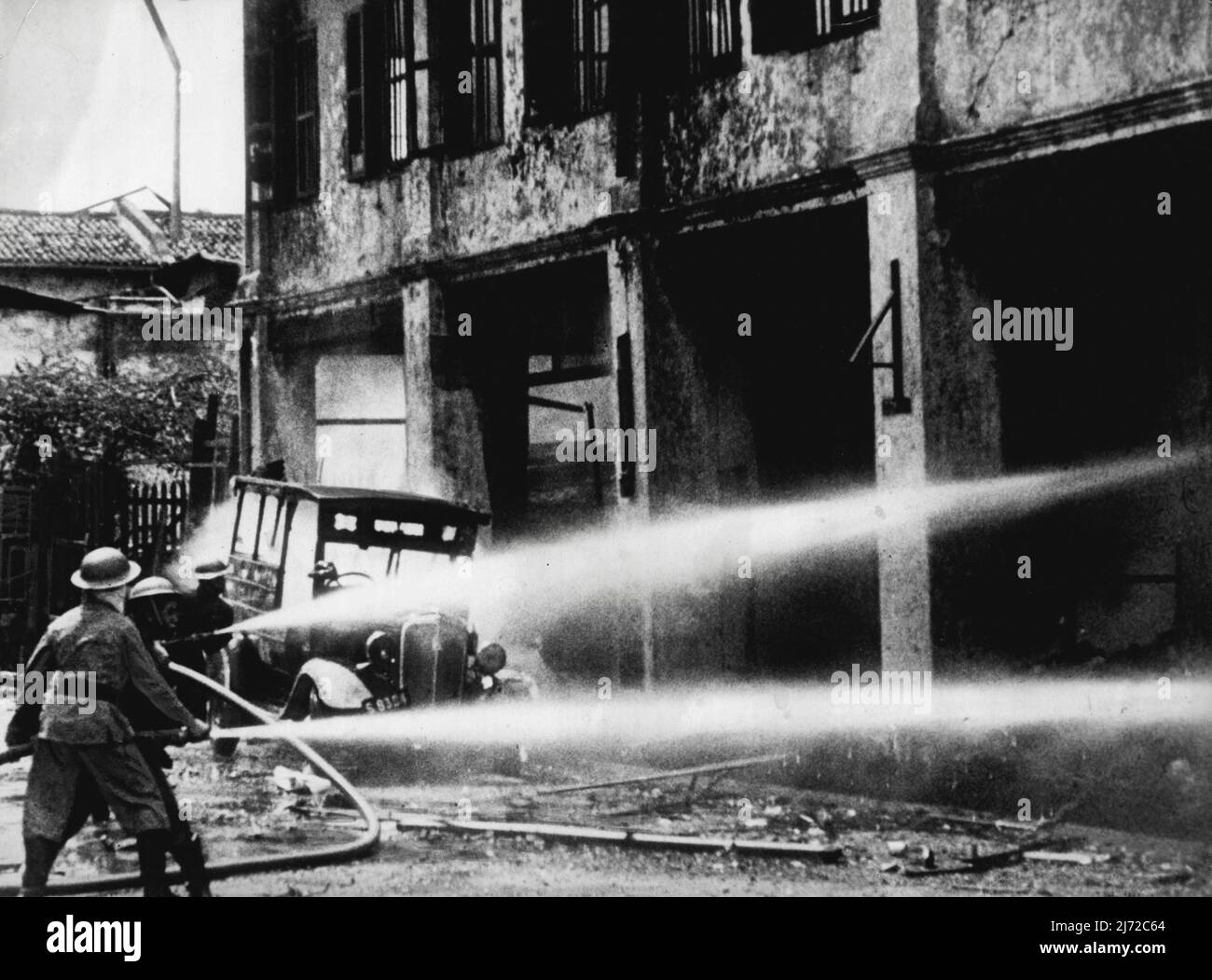 Dealing with a fire caused by Japanese incendiary bombs during a raid ...